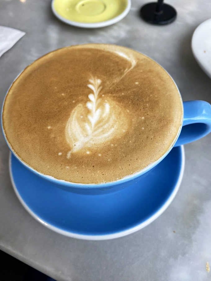 Latte art so pretty you almost don't want to drink it. Almost. That blue cup adds the perfect pop of color to your Instagram feed.