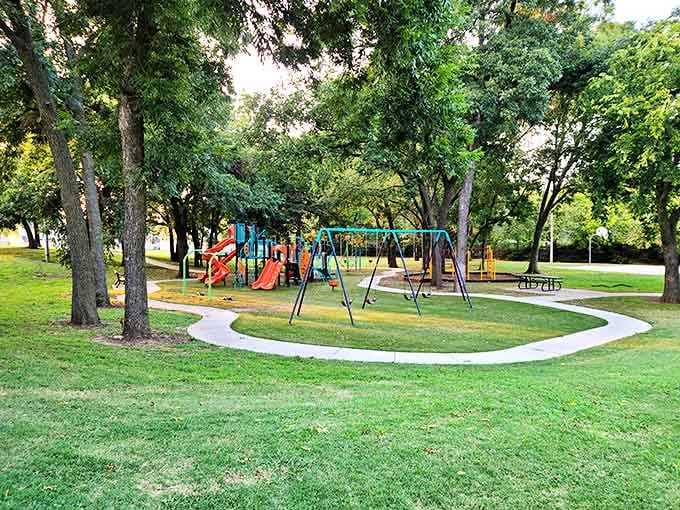 This neighborhood park's playground sits nestled among mature trees, offering multi-generational fun. Grandparents get shade while grandkids get adventure.