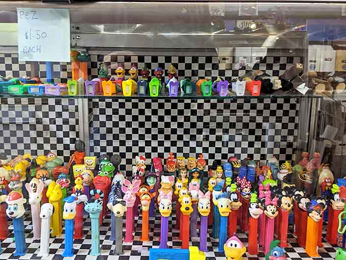 A rainbow army of PEZ dispensers stands at attention&mdash;candy-dispensing sculptures that somehow became cultural icons one cartoon head at a time.