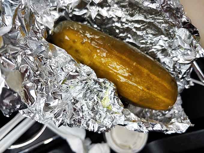 The humble pickle, wrapped in foil like Olympic medal, provides the perfect acidic counterpoint to all that meaty richness.