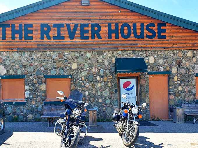 The River House's stone-and-wood exterior practically screams "motorcycles welcome," proving that rustic and cool are perfect neighbors.