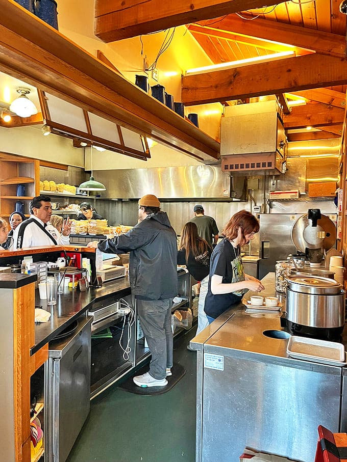 The open kitchen reveals the magic behind the meals. These aren't just cooks&mdash;they're seafood alchemists turning the day's catch into edible gold.