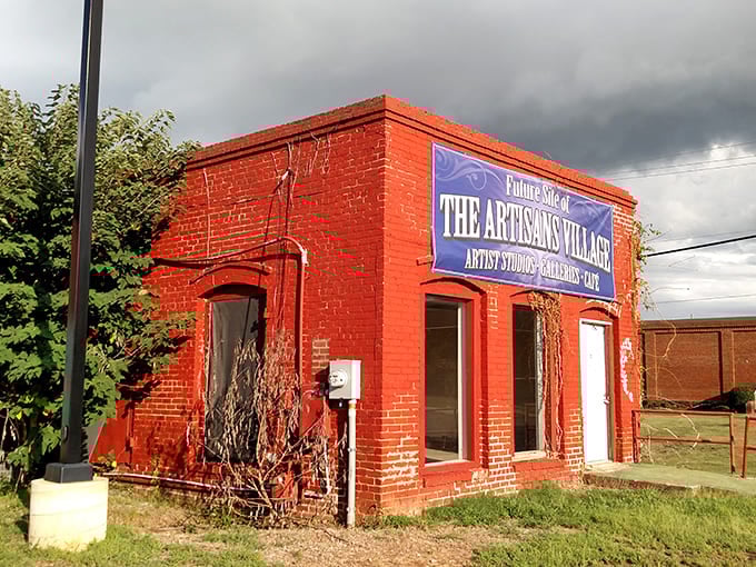 The vibrant red Artisans Village Gallery pops against stormy skies, a testament to how art brings color to even the grayest Georgia day.