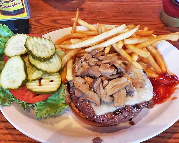 This mushroom-topped burger with its melty cheese blanket makes a compelling case for skipping dinner conversation altogether. The fries are just showing off.