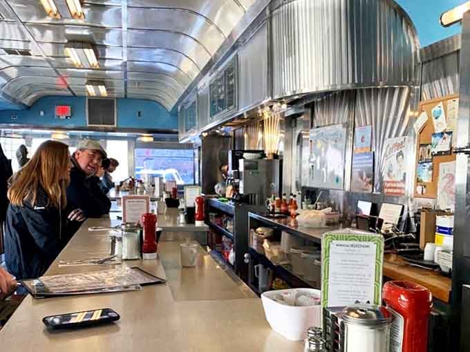 The counter view that makes you feel like you've stepped into an Edward Hopper painting, except with better lighting and unlimited coffee.