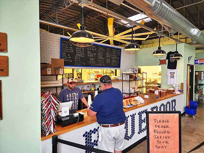 The counter where barbecue dreams come true, complete with the polite reminder to order before sitting&mdash;civilization at its finest.