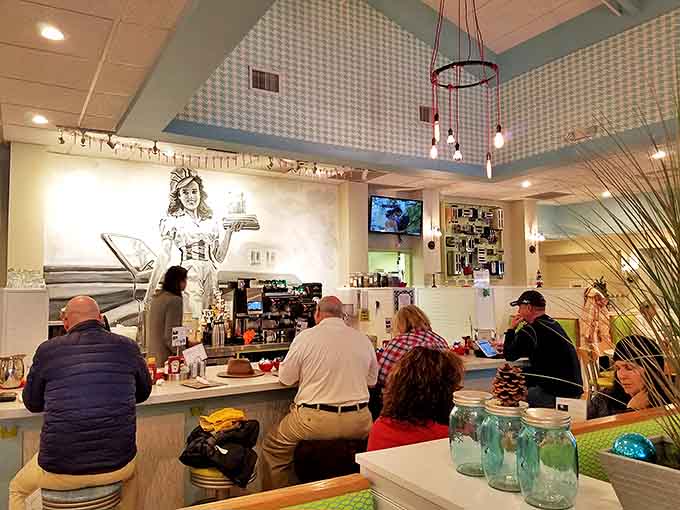 Counter seats offer front-row tickets to the breakfast theater, where morning magic happens under the watchful gaze of vintage-inspired décor.