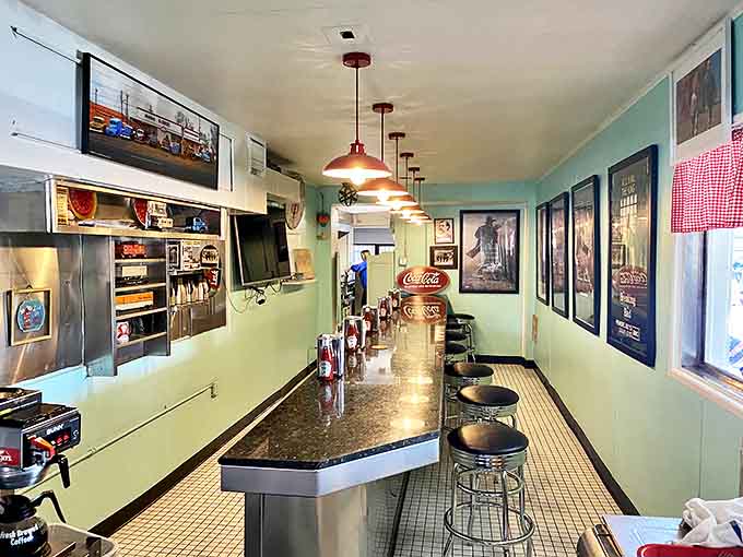 The mint-green counter area offers front-row seats to the breakfast theater – where coffee flows and regulars hold court.