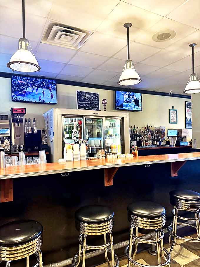 The bar area stands ready for those who understand that sometimes breakfast calls for something stronger than orange juice. Those classic diner stools have heard all your morning confessions.