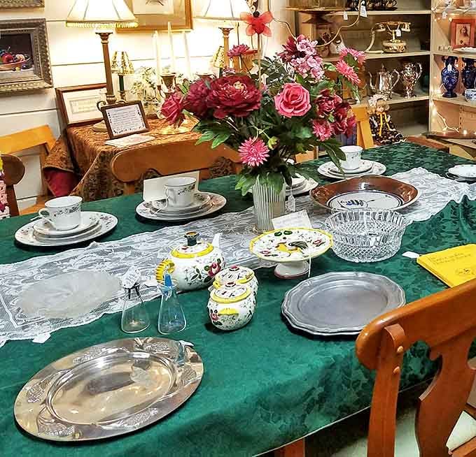A formal table setting awaits imaginary guests from the past—silver platters and delicate teacups ready for a Downton Abbey-worthy gathering.