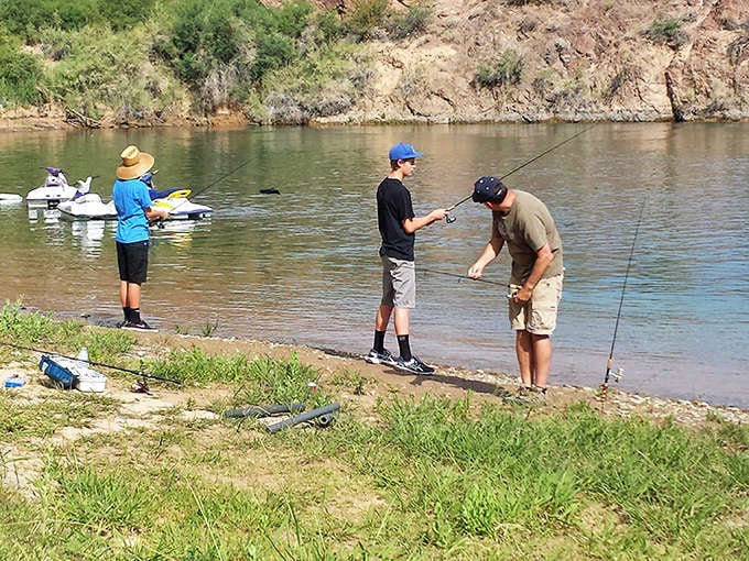 Fishing lessons and family bonding happen simultaneously along these shores. The river provides both dinner and entertainment.