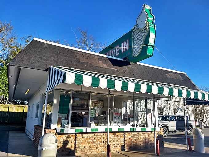Morning light showcases the green and white striped awning, a familiar landmark that's weathered storms both literal and economic while keeping its promise of consistency.