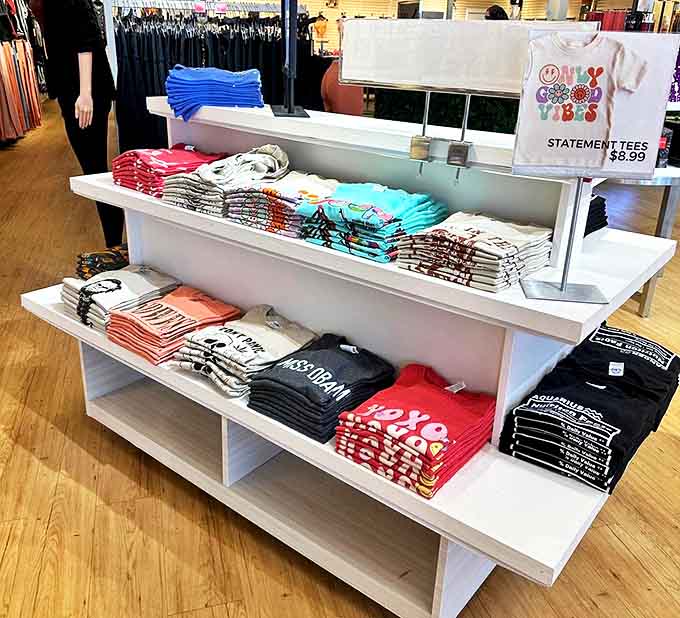 Graphic tees arranged in a rainbow of options &ndash; because sometimes your shirt should do the talking when your coffee hasn't kicked in yet.