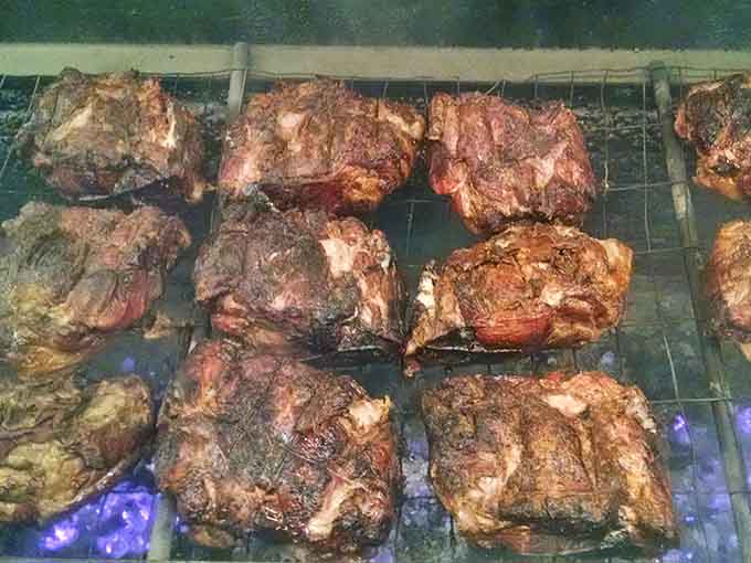 Sizzling cuts over open flames—this is where the magic happens, one careful turn at a time.