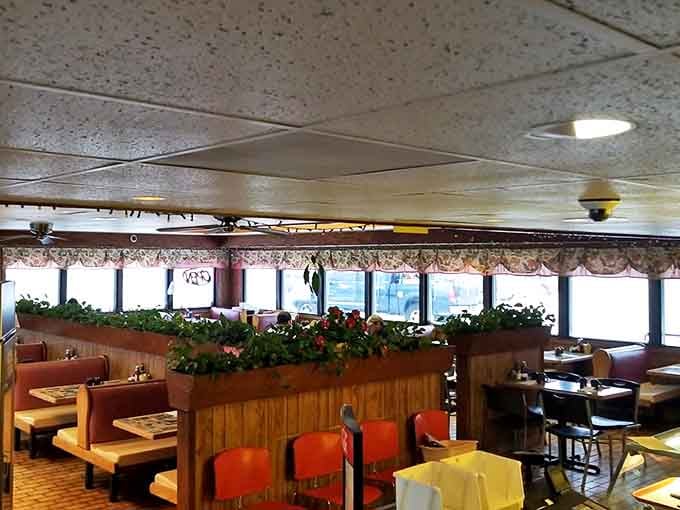 Plants and privacy dividers create little dining sanctuaries. Your conversation about last night's aurora viewing stays private.