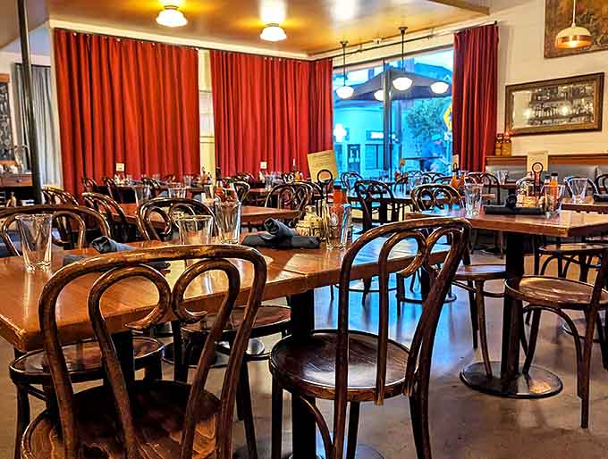 Red curtains frame the dining room like a stage where the real stars are the plates arriving at each table.