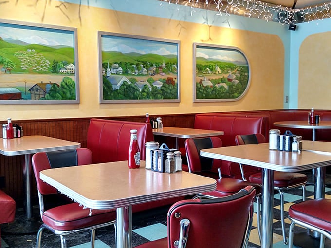 The dining area&mdash;where red vinyl booths have witnessed decades of first dates, family celebrations, and travelers finding their way through Vermont's scenic beauty.