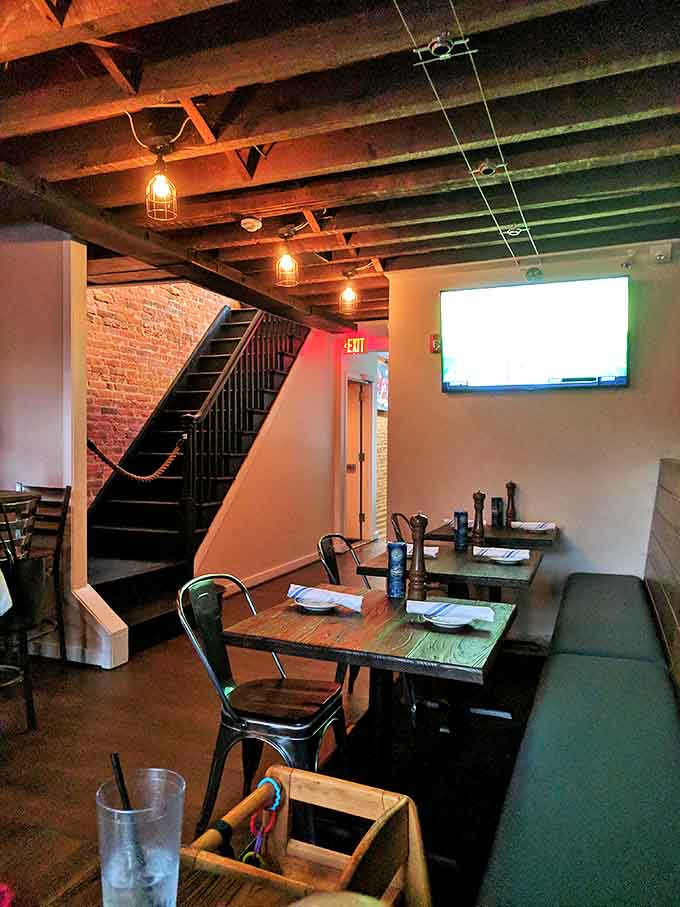 The dining room's exposed beams and industrial-chic lighting create that rare atmosphere where both first dates and family dinners thrive equally.