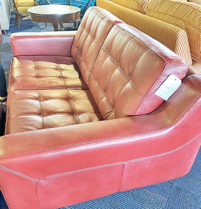Mid-century modern meets contemporary comfort in this coral leather loveseat. Don Draper would approve of its clean lines and bold statement color.