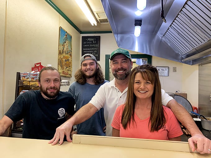 The smiling faces behind the magic. These burger artisans have probably made more people happy than most therapists.
