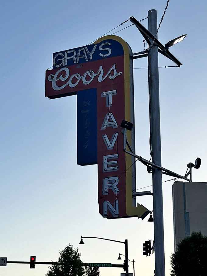 That vintage vertical sign stands tall, guiding hungry travelers to tavern salvation since way back when.