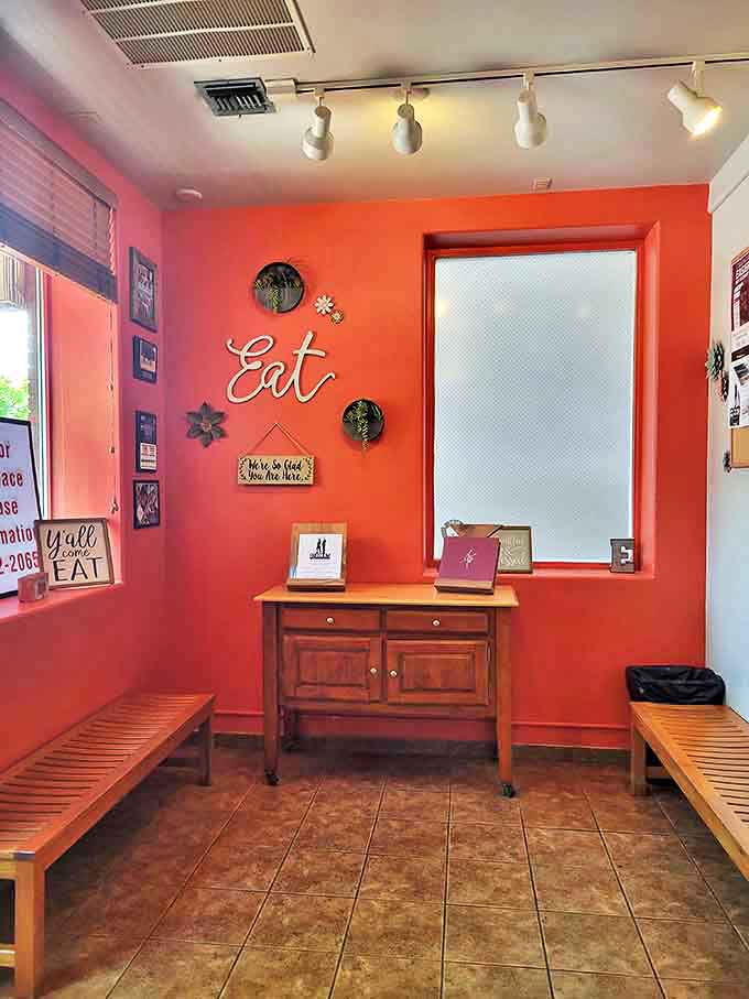 The coral-colored waiting area with its "Eat" sign and welcoming message isn't just telling you what to do—it's offering life advice worth following.