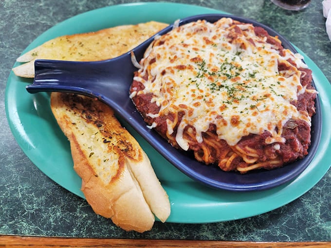 Baked spaghetti with a blanket of melted cheese that stretches dramatically with each forkful &ndash; comfort food that hugs you from the inside.