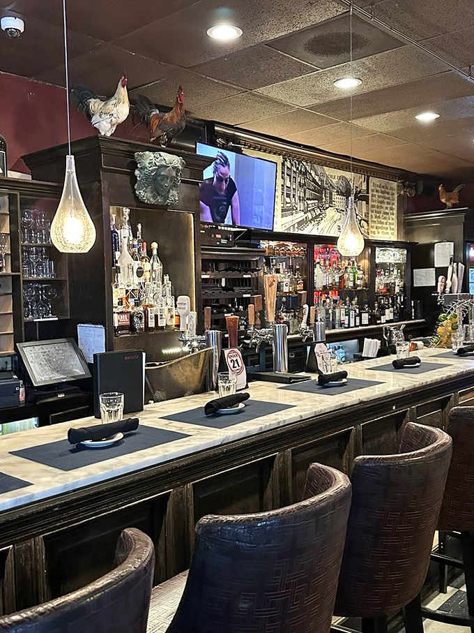 The bar area, crowned with decorative roosters, where expertly crafted cocktails await after a long workday or before a special dinner.