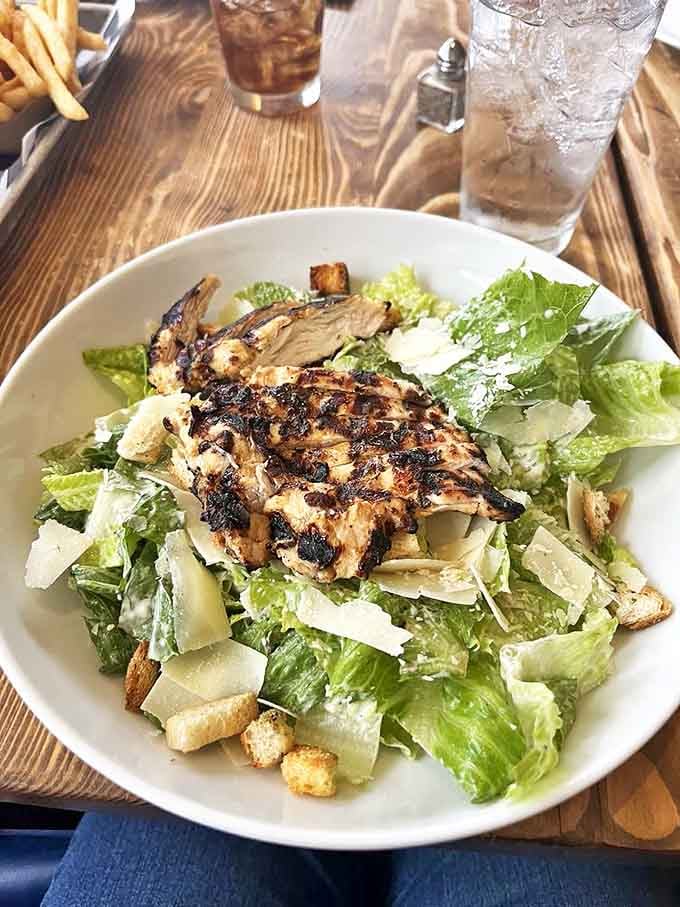 A Caesar salad that respects the classics while adding grilled chicken that actually tastes like something. Simple food done right never goes out of style.