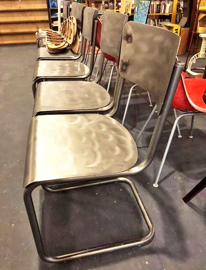 Mid-century classroom chairs lined up like soldiers, ready for their second act. They've supported generations of squirming students and still look ready for duty.