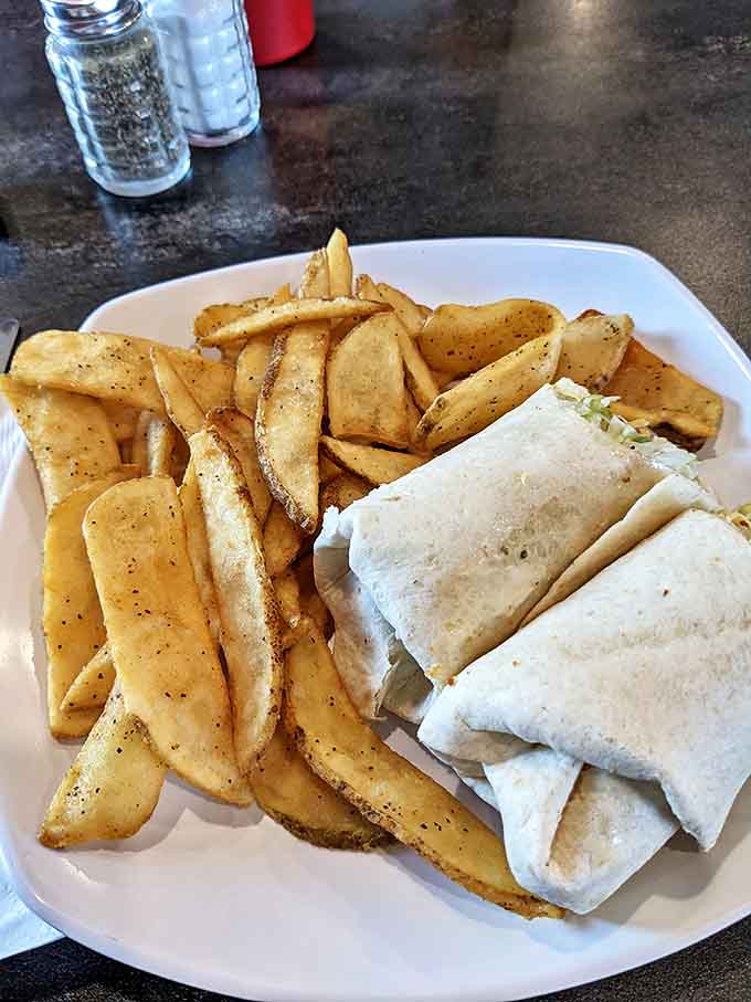 The wrap that answers the eternal question: "What if we took everything delicious and rolled it into a portable feast with perfectly seasoned fries?"