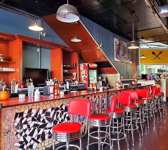 Classic diner counter with checkerboard accents&mdash;the kind of place where regulars don't even need to order because the staff already knows.
