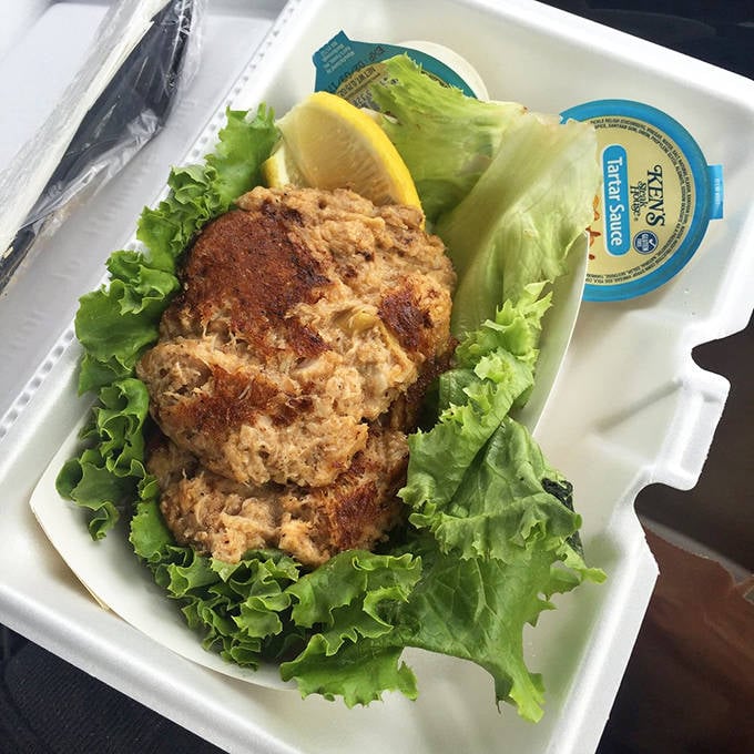 Crab cakes done right: mostly crab, minimal filler, perfectly seared, and served on crisp lettuce with a lemon wedge for brightness.