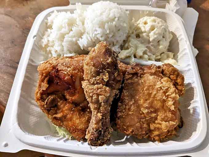 Fried chicken so perfectly golden it belongs in Fort Knox, served with the obligatory two scoops of rice and mac salad.