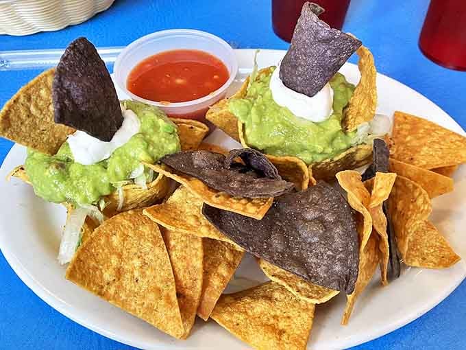 Nachos that understand the importance of proper distribution. Every chip gets its fair share of guacamole, sour cream, and that vibrant salsa.