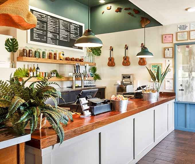A counter that says "Aloha" without a word. Potted plants stand by like green ambassadors welcoming you to flavor country.