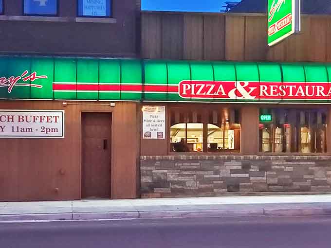 The warm glow of Sammy's Pizza beckons hungry visitors with the promise of that perfect thin crust that's kept locals coming back since long before online ordering.
