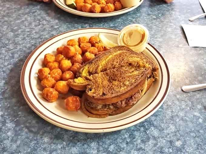 A masterpiece of comfort food artistry: golden tater tots and a perfectly grilled sandwich that makes chain restaurant offerings look like sad afterthoughts.