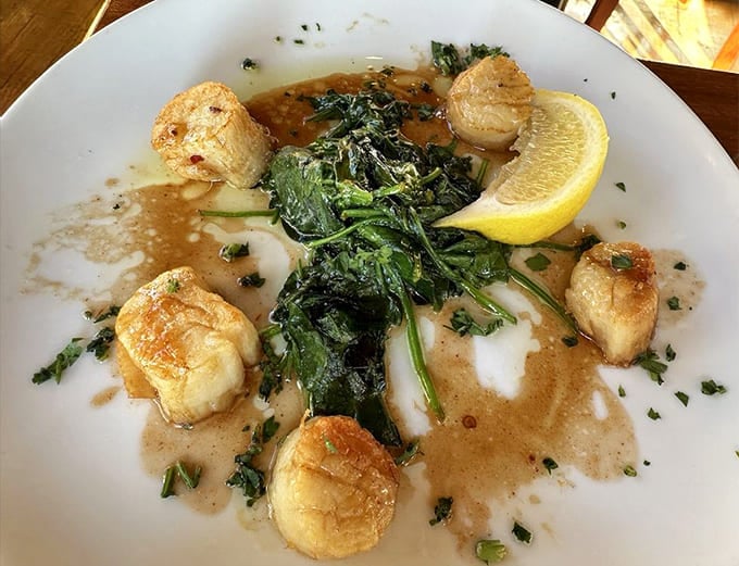 Perfectly seared scallops swimming in buttery sauce with greens&mdash;ocean candy for grown-ups that might make you consider moving to Newport permanently.