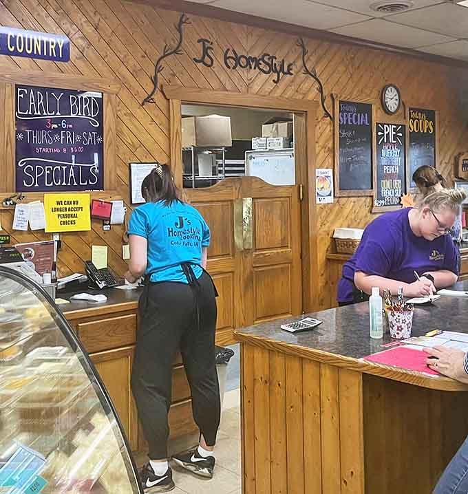 The breakfast ballet in action—J's staff orchestrating the morning rush with practiced precision. Those blue shirts have seen it all.