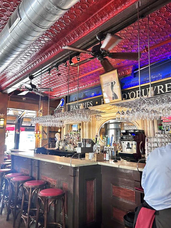 The bar at Leunig's doesn't just serve drinks&mdash;it serves possibilities, all under that magnificent red ceiling that feels like dining inside a vintage jewelry box.