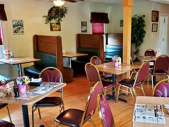 Wooden booths create intimate dining spaces where memories are made between bites of perfectly prepared Iowa beef.