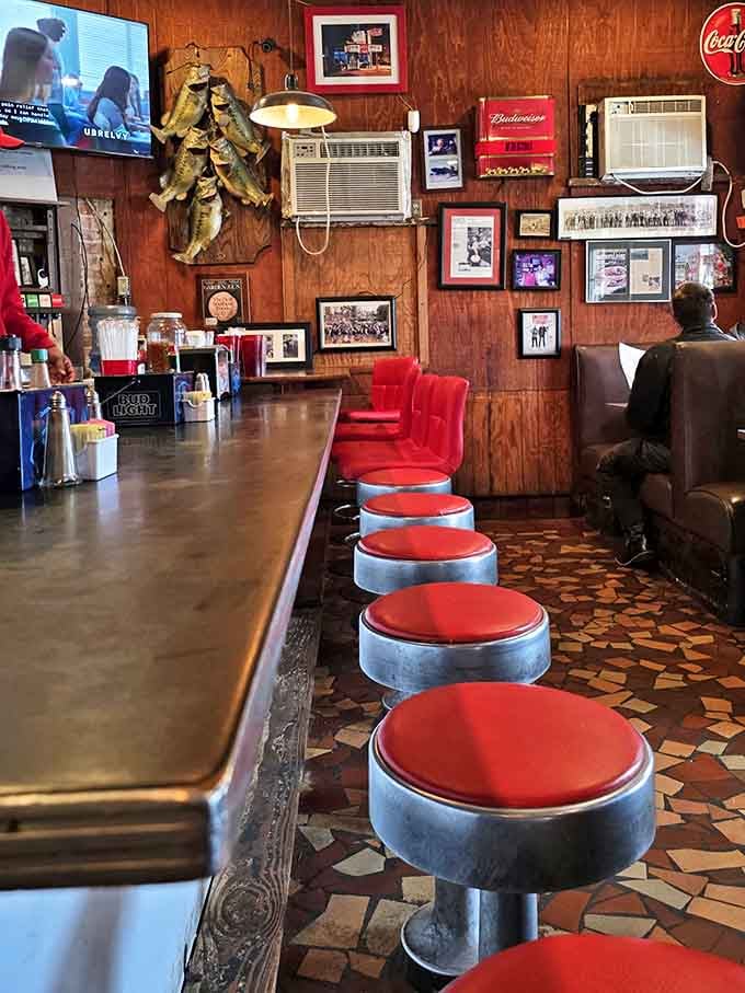 The counter where strangers become friends and regulars become family. Those red stools have supported more stories, celebrations, and everyday moments than any therapist's couch.