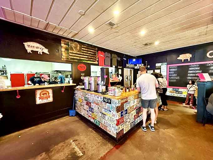 The counter where BBQ dreams come true. That license plate collage tells you you're somewhere with personality, not some corporate chain.
