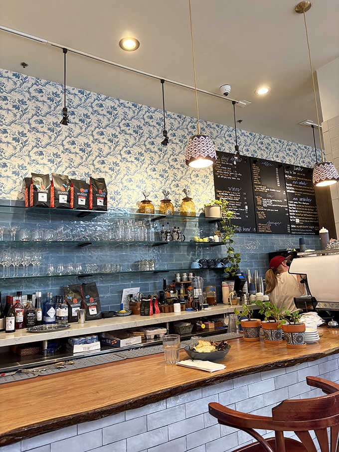 The counter at Ellie's showcases the blue tile and floral wallpaper that transport you straight to a European caf&eacute; without the airfare.