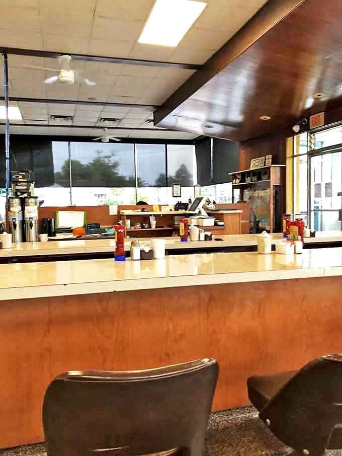 The counter where regulars perch like birds on a wire, watching the kitchen ballet while trading neighborhood news and friendly banter.
