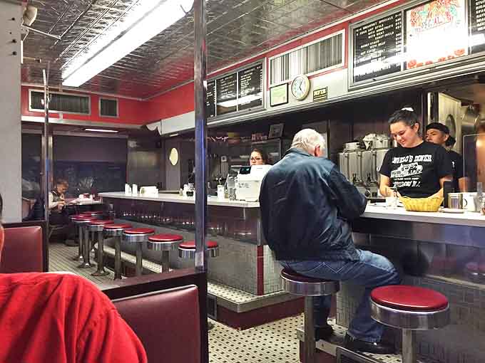 The counter view – where you can watch your breakfast being born while eavesdropping on conversations that are better than anything on Netflix.
