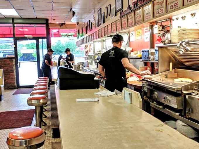 Bright yellow and orange booths pop against the classic diner backdrop &ndash; a color scheme that says "happiness served here."