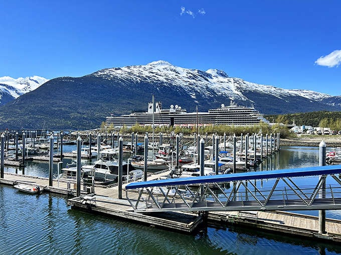 Harbor reflections create perfect symmetry between mountain and marina &ndash; a reminder that in Alaska, even the parking spots come with million-dollar views.