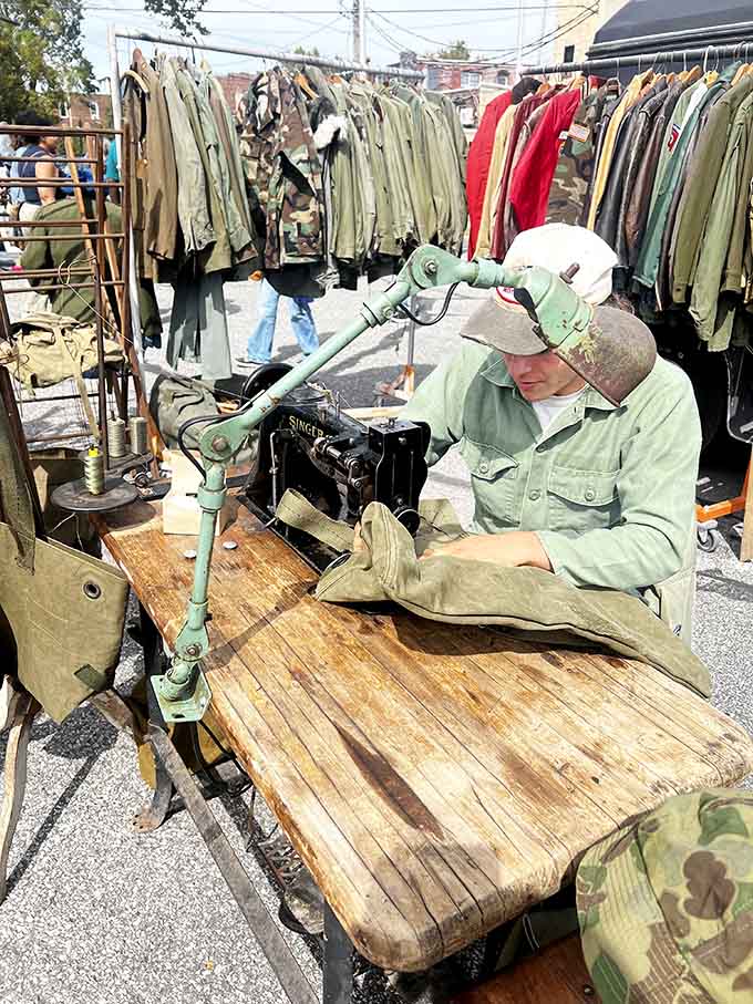 Military surplus meets craftsmanship as a vendor breathes new life into vintage fabrics, his sewing machine a time-traveling wizard.